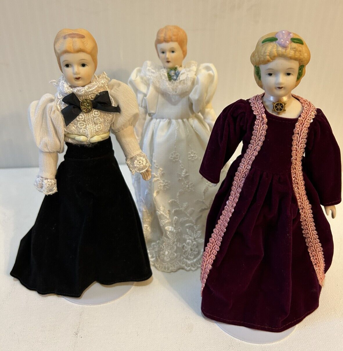 Porcelain Dolls Period Dresses Set of Three w/stands