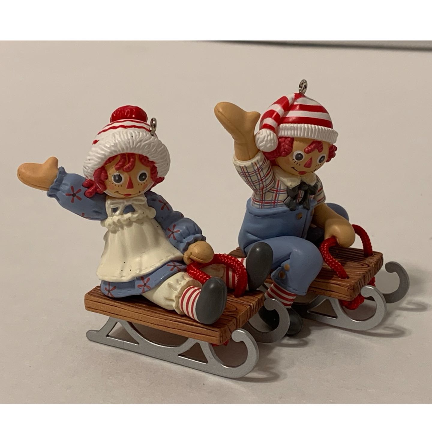 2005 Hallmark Raggedy Ann & Andy Sledding Ornament Pair